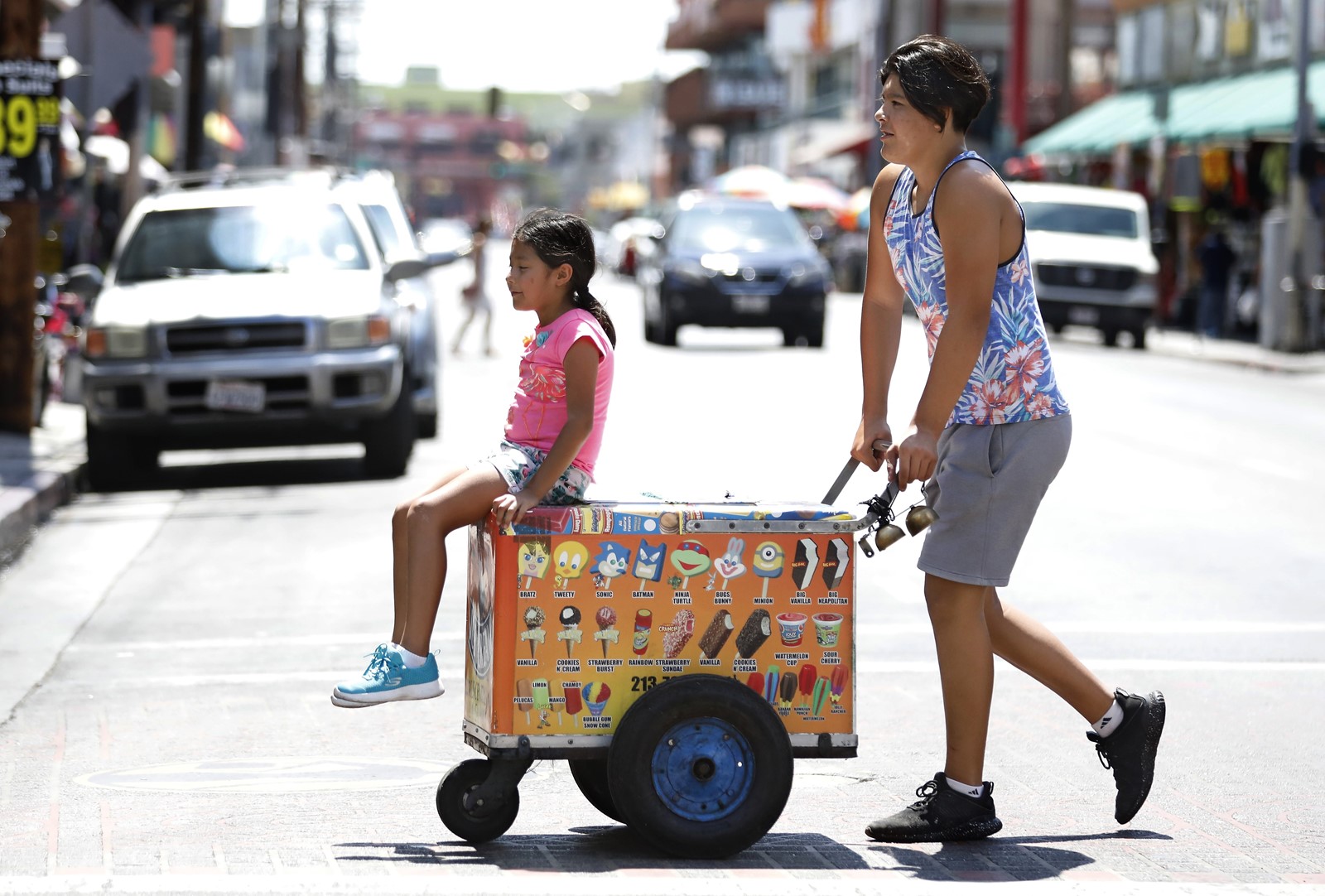 ADRIAN VALDIVIA gives Acacia Valencia a ride on an ice cream cart ...