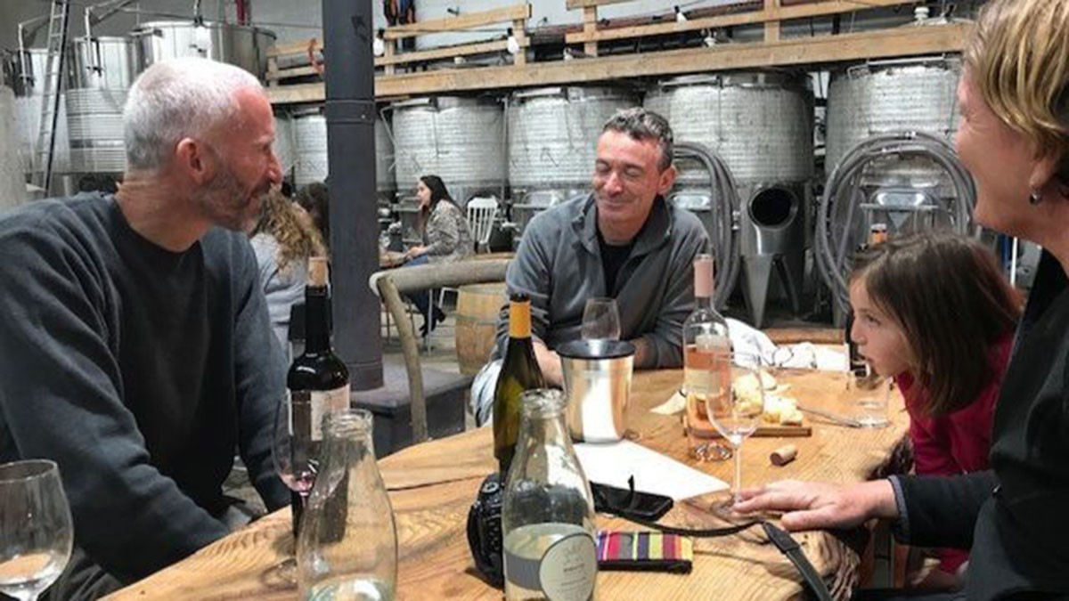 VINTNER Tal Pelter, left, chats with customers at his Golan Heights ...